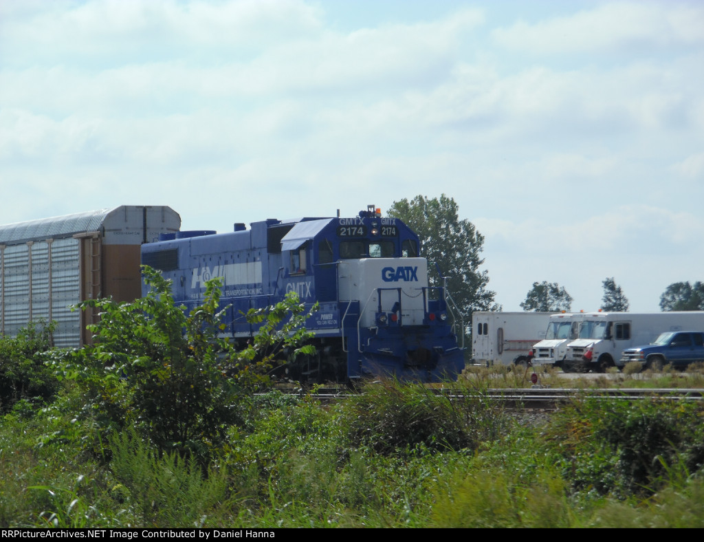GMTX 2174 switches a cut of cars in the yard